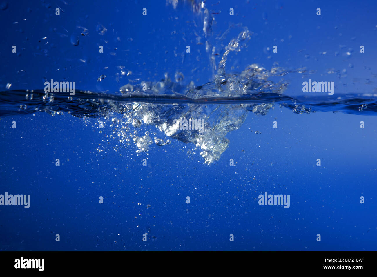 Blue water falling like splash close up macro side view Stock Photo - Alamy