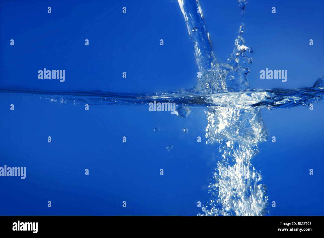 Blue water falling like splash close up macro side view Stock Photo - Alamy