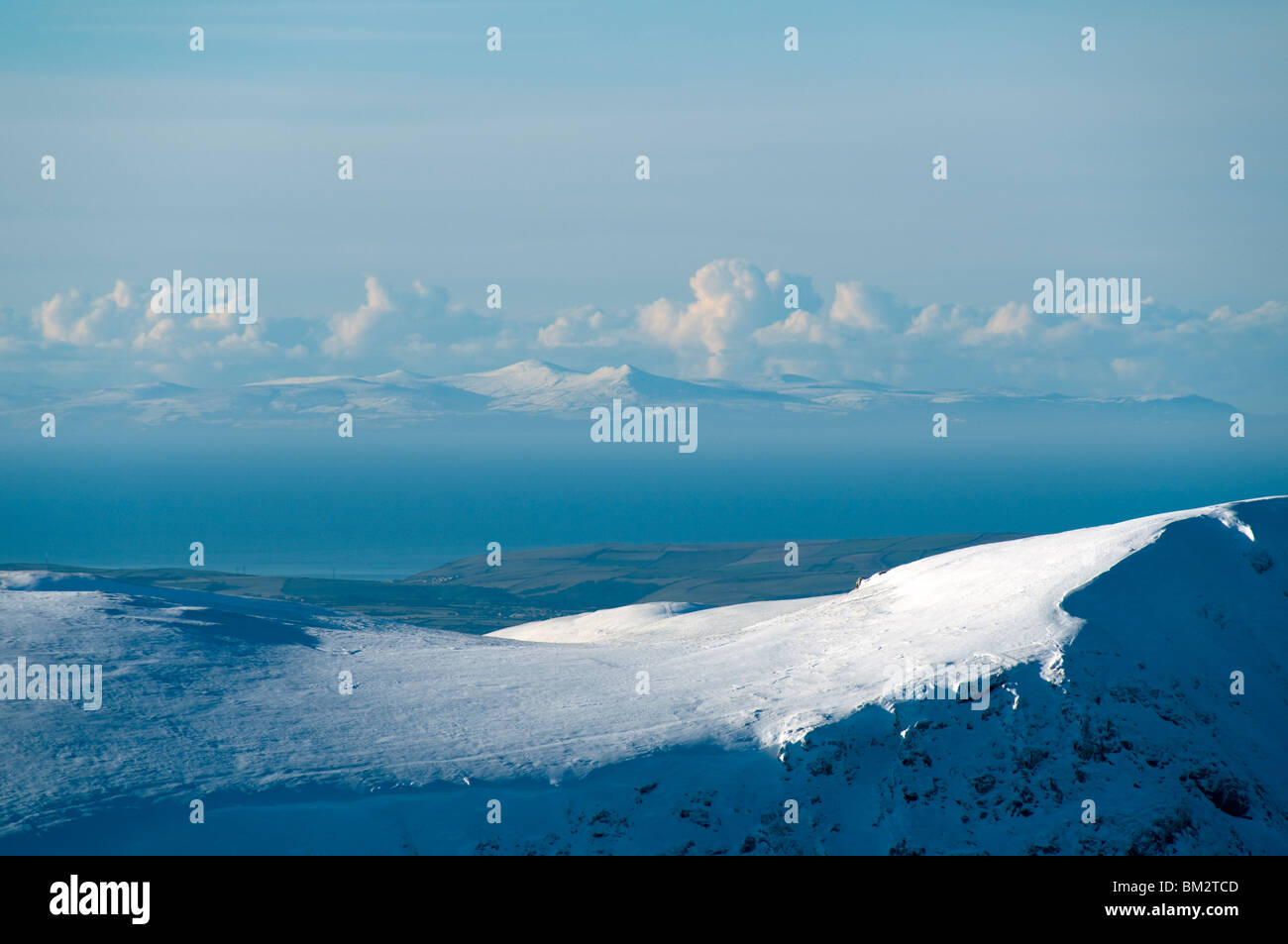 A distant view of the Isle of Man from Grisedale Pike in winter ...