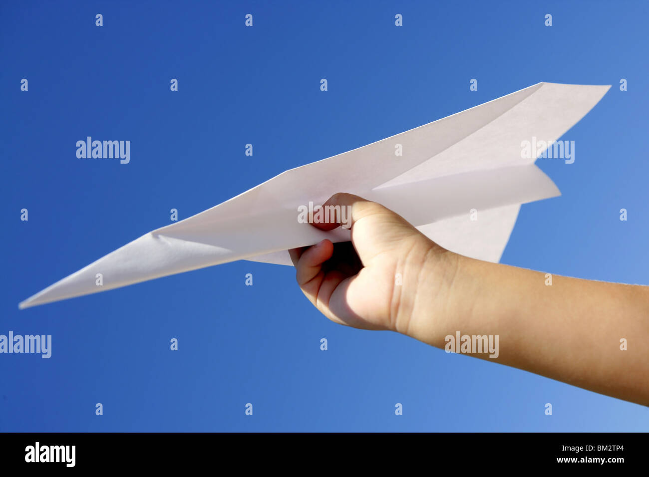 Paper airplane in children hand over sunny summer blue sky Stock Photo ...