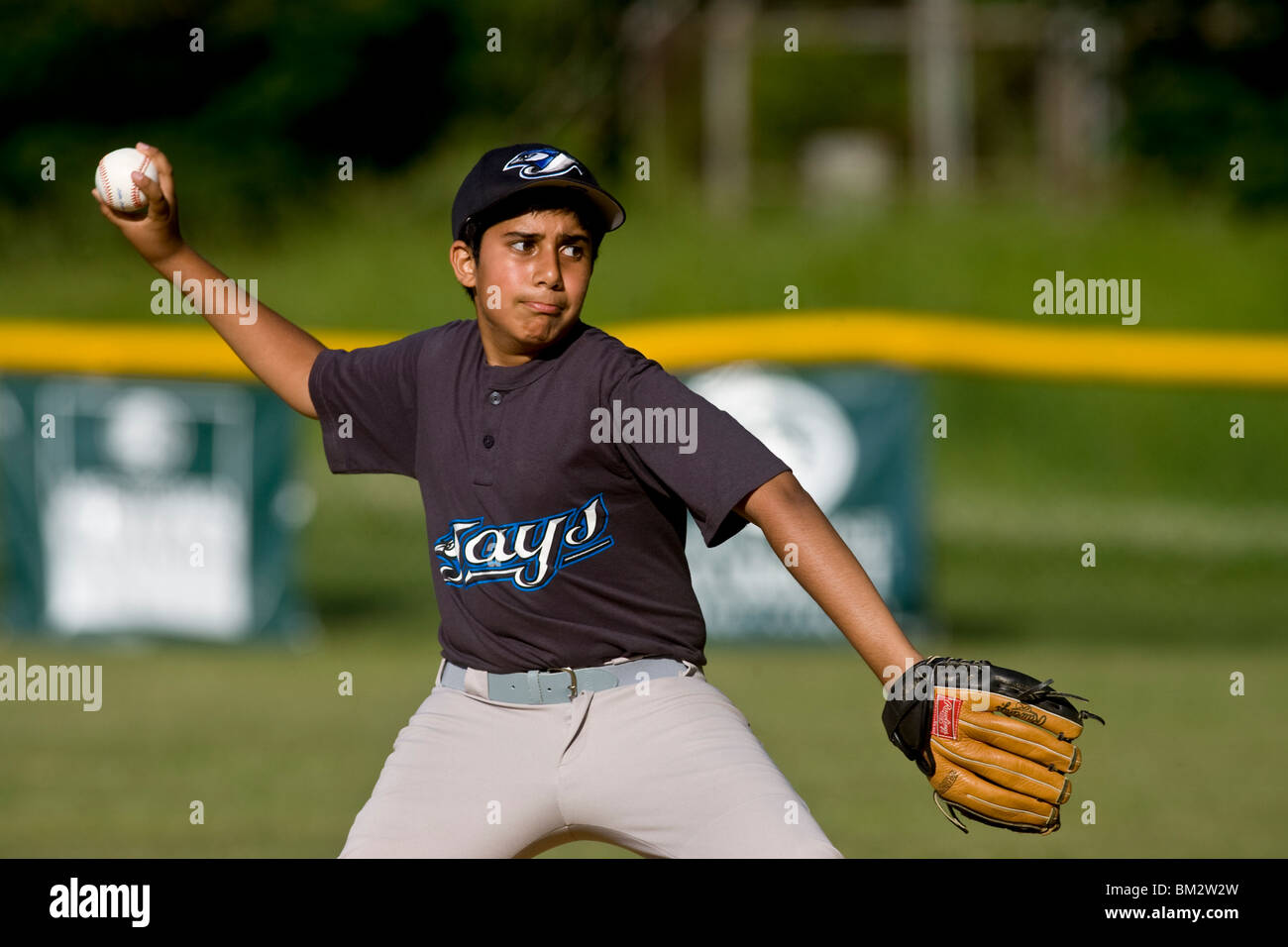 Pitcher in action during boy's little league baseball game Stock Photo ...