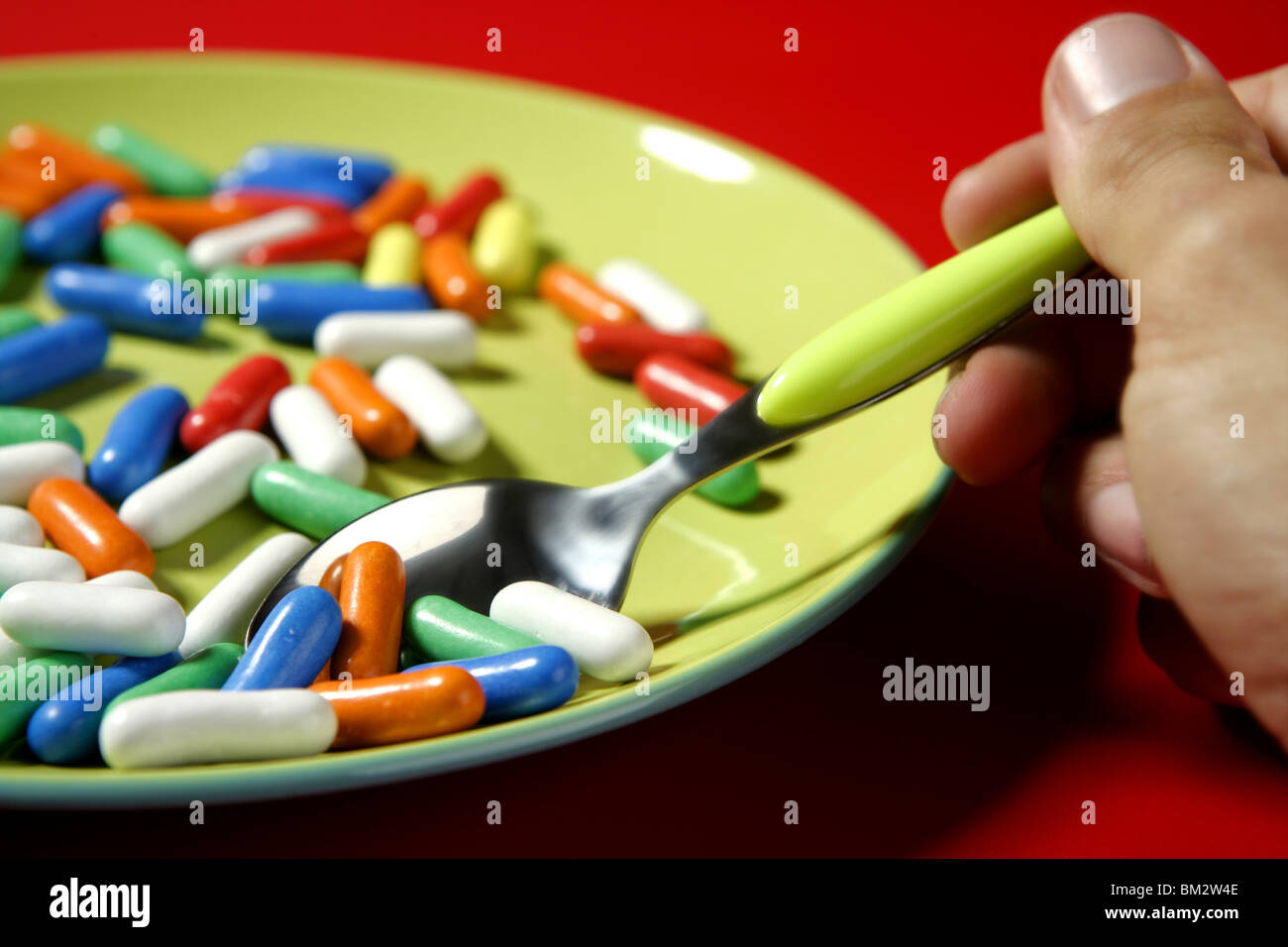 Children favourite menu, sweet colorful little candy in green plate ...