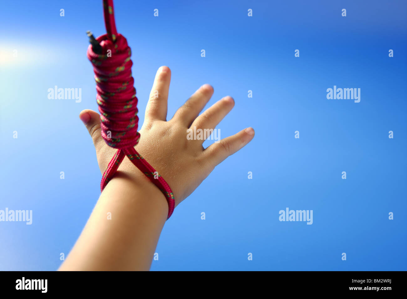 Children hand hanged on red thread, hangman knot, education metaphor ...