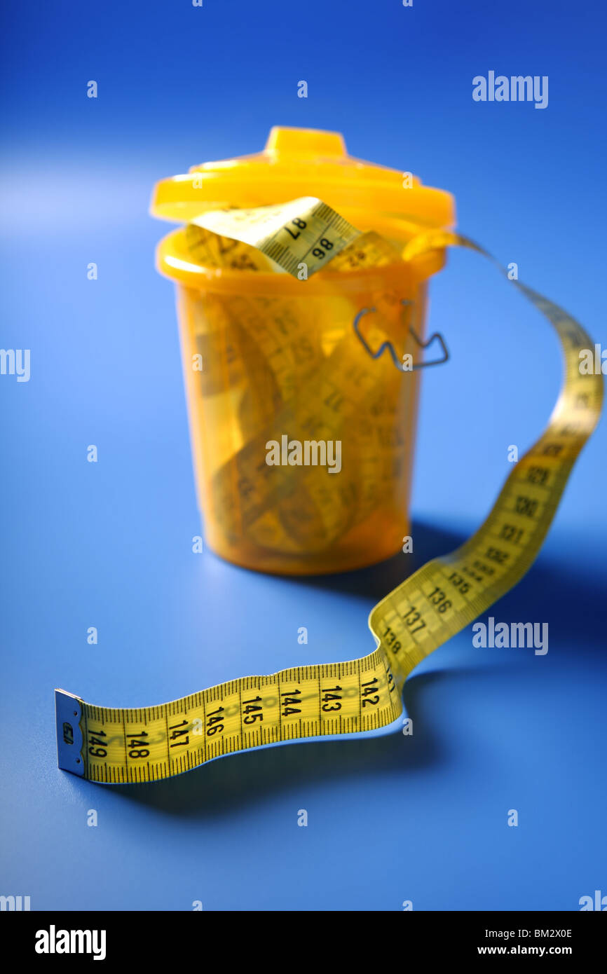 Centimeter tape meter on the trash, end of diet care metaphor Stock ...