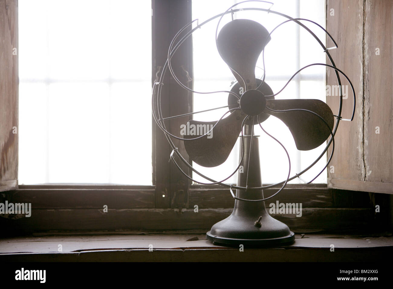 Antique vintage air fan in the window backlight Stock Photo - Alamy