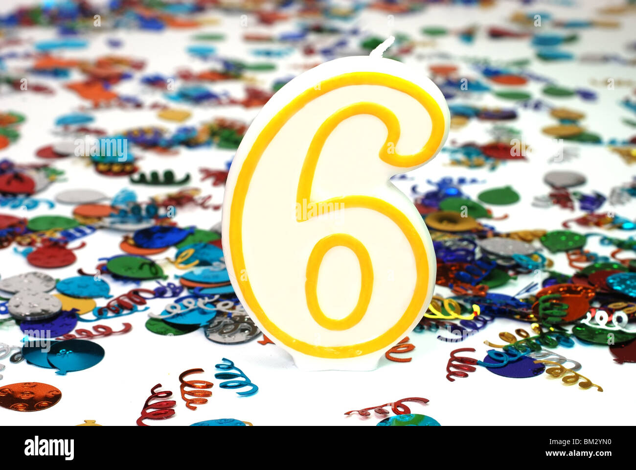 Number 6 celebration candle with confetti Stock Photo - Alamy