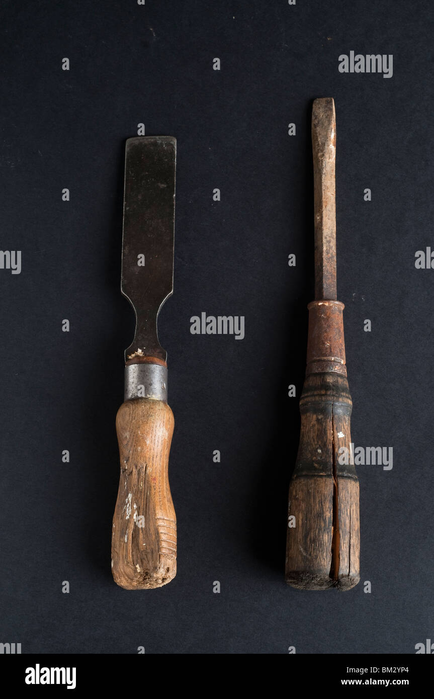 old worn screwdriver and chisel on black Stock Photo - Alamy