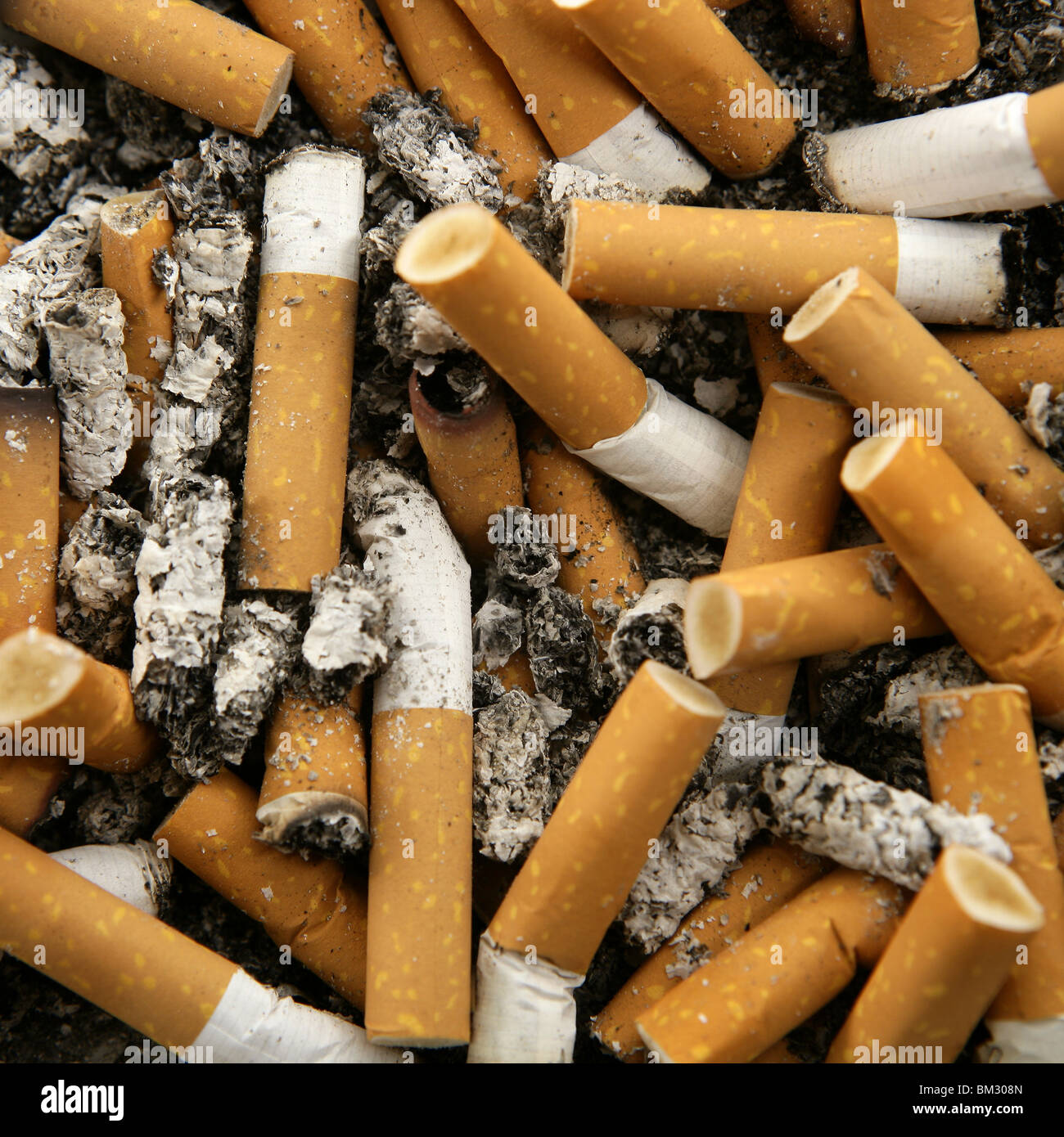 cigarettes texture, busy ashtray square still shot Stock Photo - Alamy