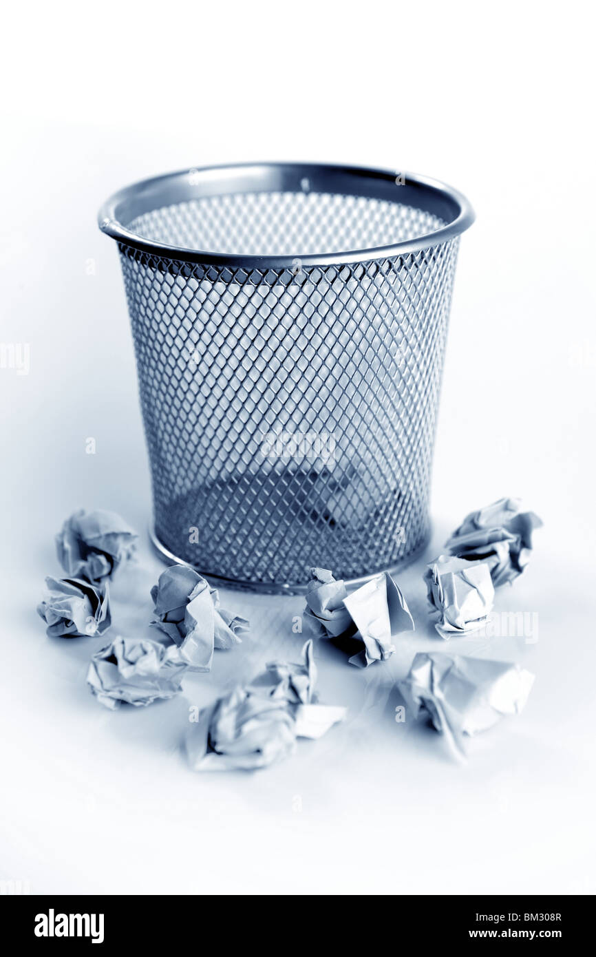 Wastebasket full of crumpled paper over white background Stock Photo ...