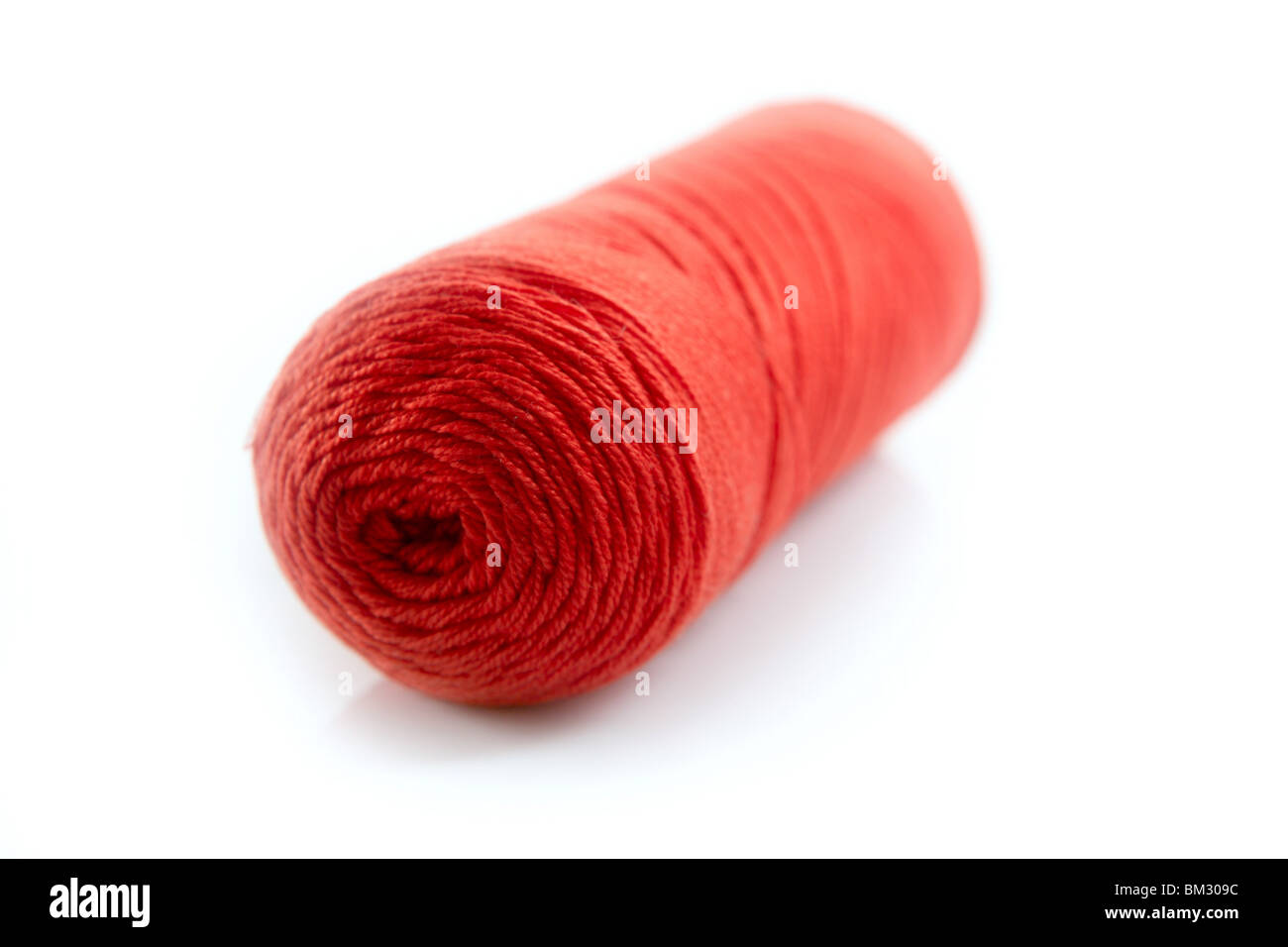 Red thread spool isolated over white studio background Stock Photo - Alamy