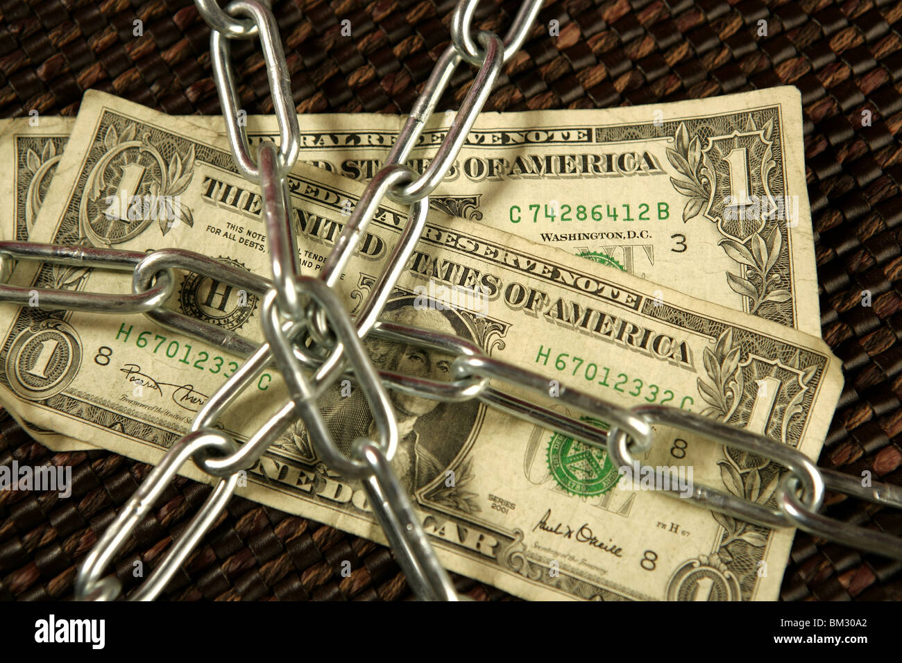One Dollar notes in chains studio shot over brown background Stock ...
