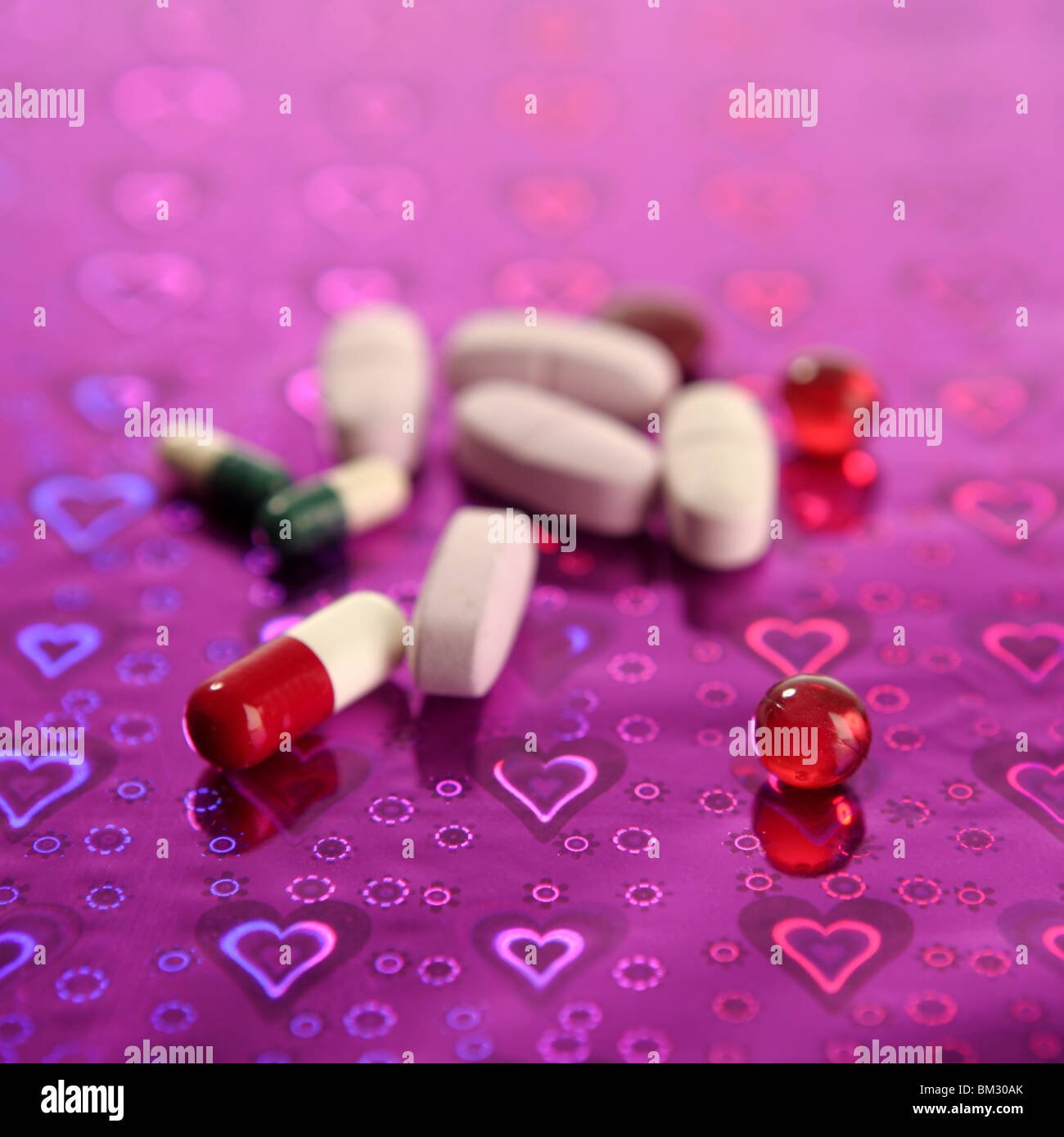 medical pills over holographic purple shiny background Stock Photo - Alamy