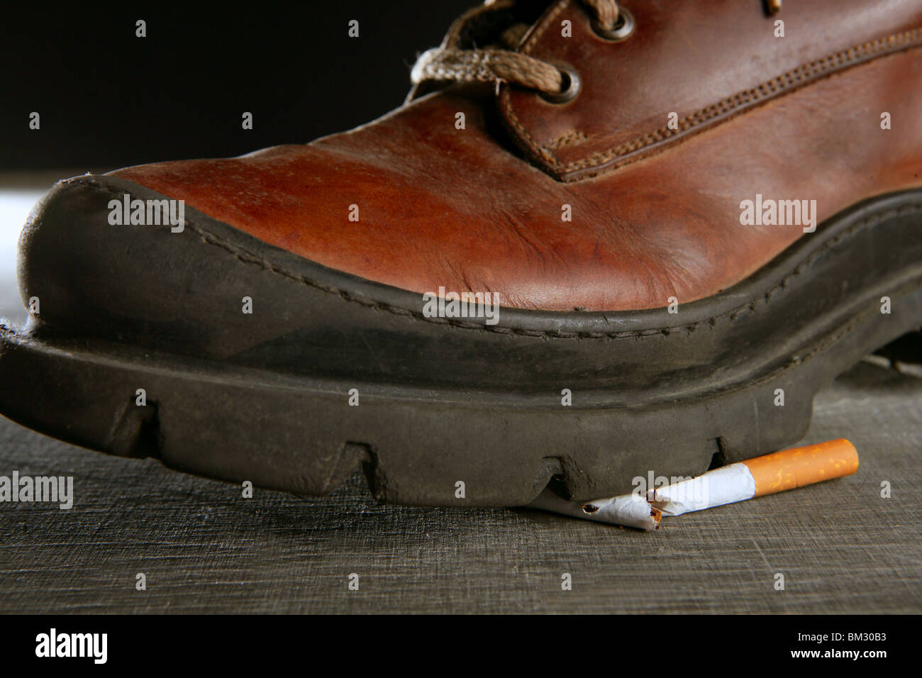 broken cigarette tread by a boot, tobacco addiction metaphor Stock ...
