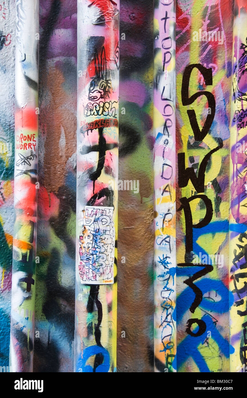 Graffiti on pipes and wall behind building in downtown Olympia ...