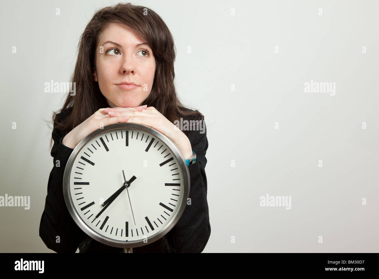 Young woman posing by clock. Isolated on white Stock Photo - Alamy