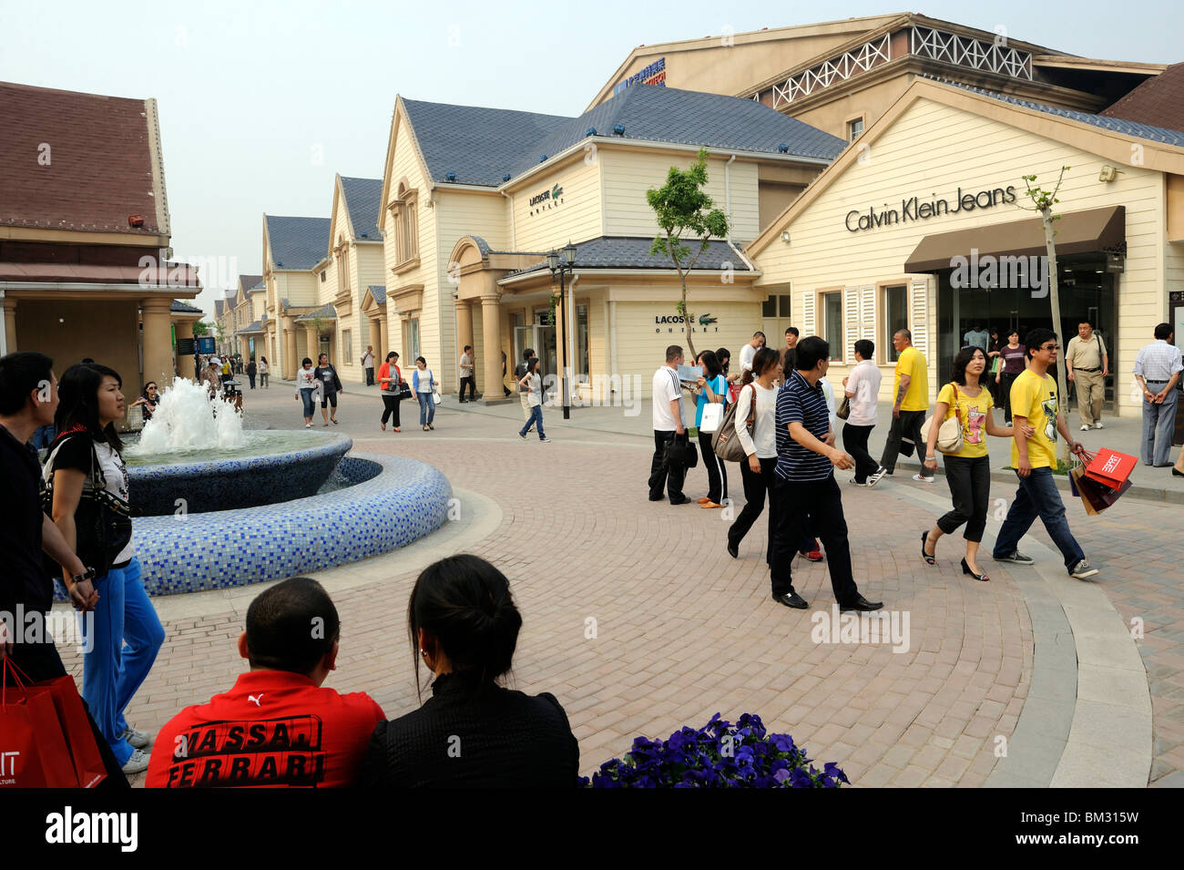 Chinese consumers walk at Beijing Scitech Premium Outlet Mall in ...
