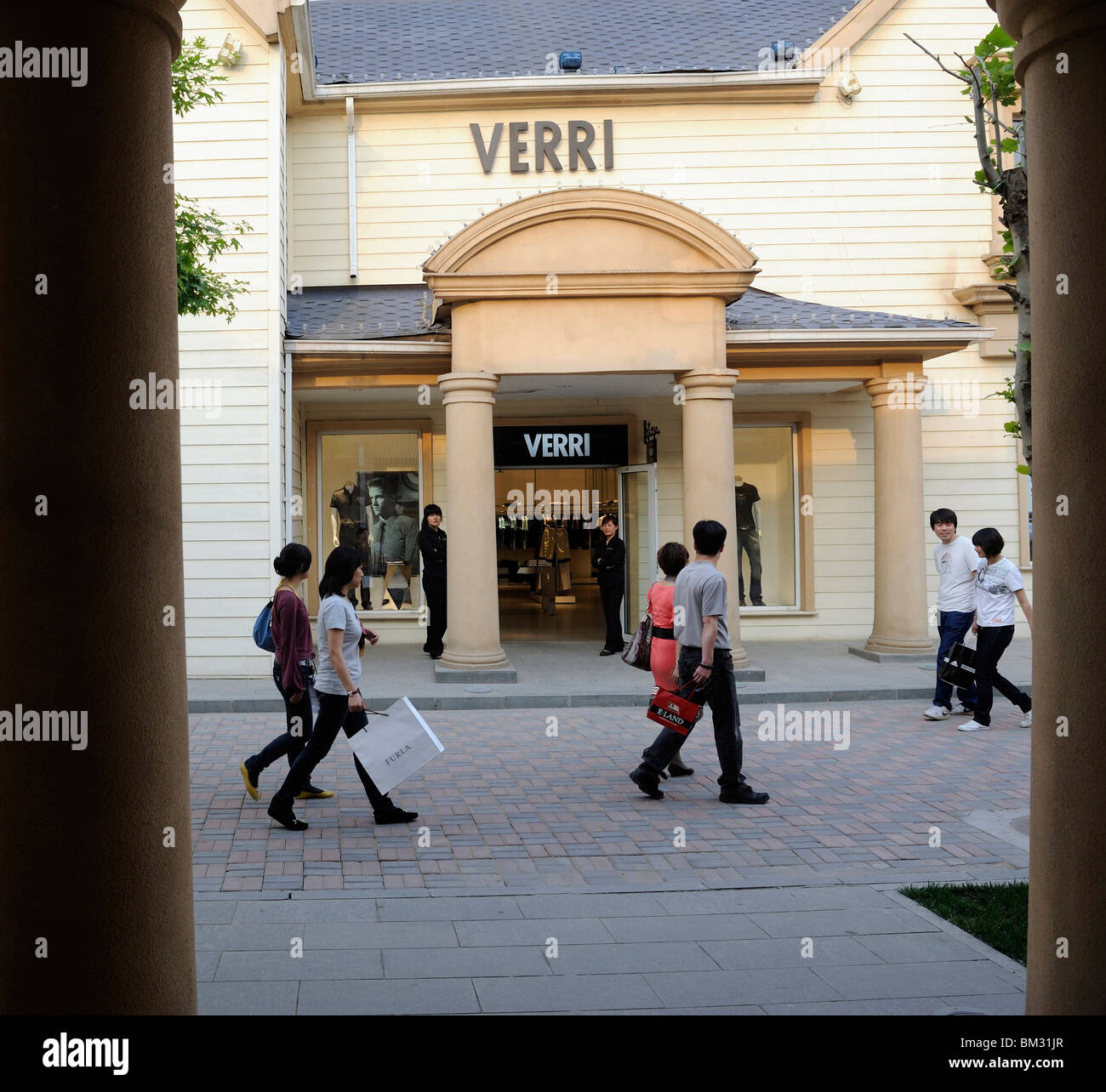 Chinese walk past Italy brand Verri billboard at Beijing Scitech ...