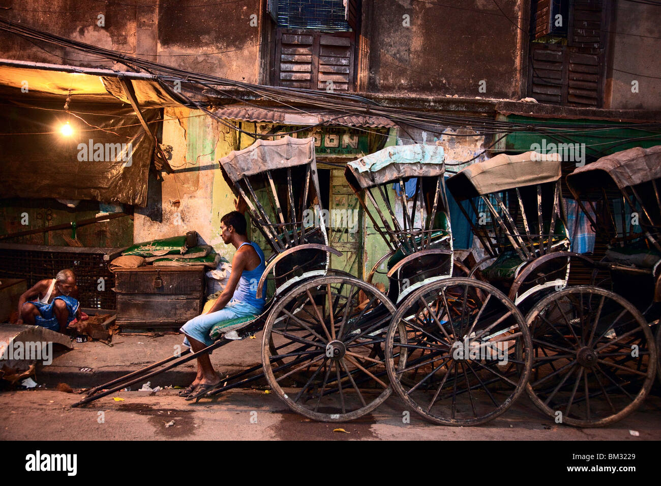 A rickshaw wallah rests in Kolkata with his buggy Stock Photo - Alamy