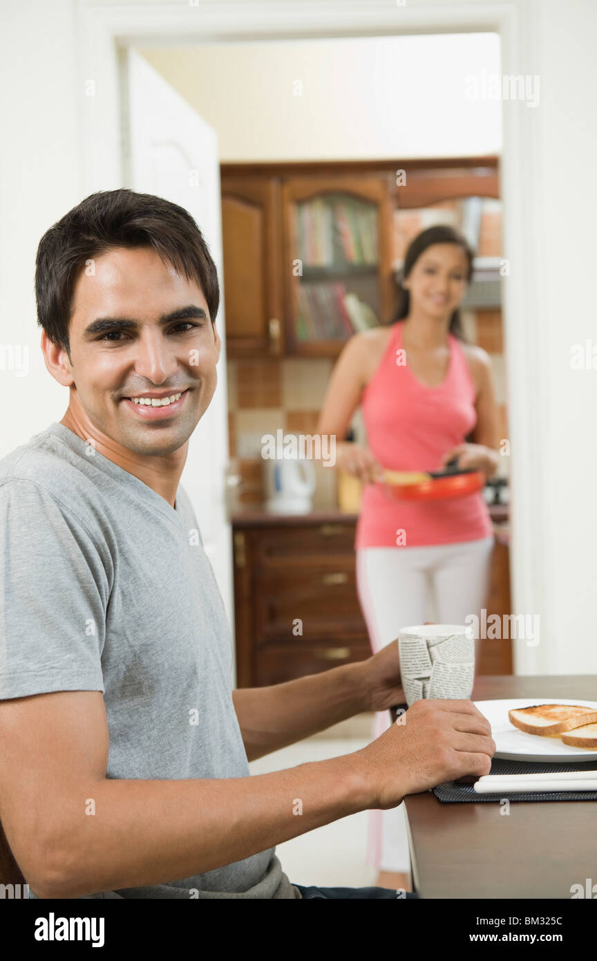 Woman serving breakfast to a man Stock Photo - Alamy