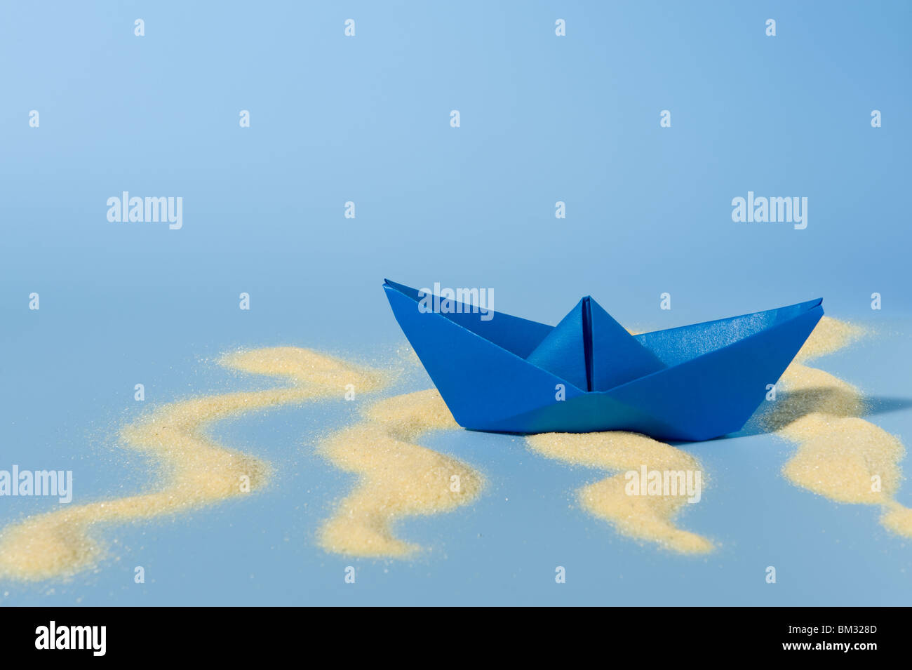blue paper boat with waves from sand Stock Photo - Alamy