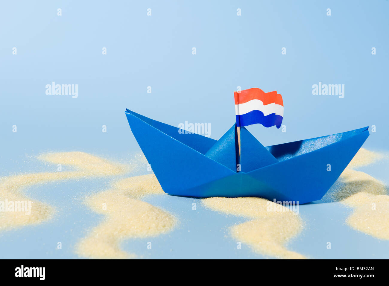 blue paper boat with waves from sand Stock Photo - Alamy
