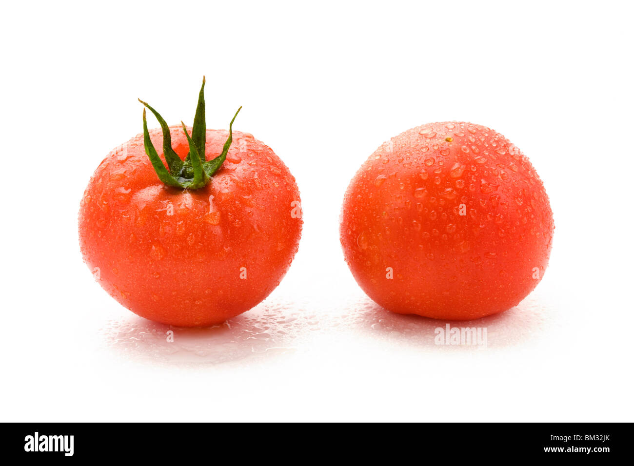 Two tomatoes on white background Stock Photo - Alamy