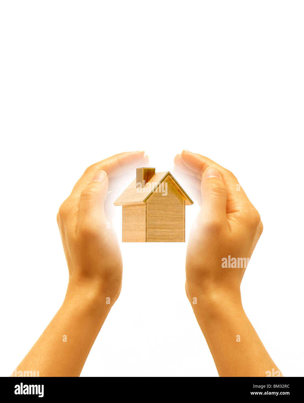 Hands holding wooden house white background Stock Photo - Alamy