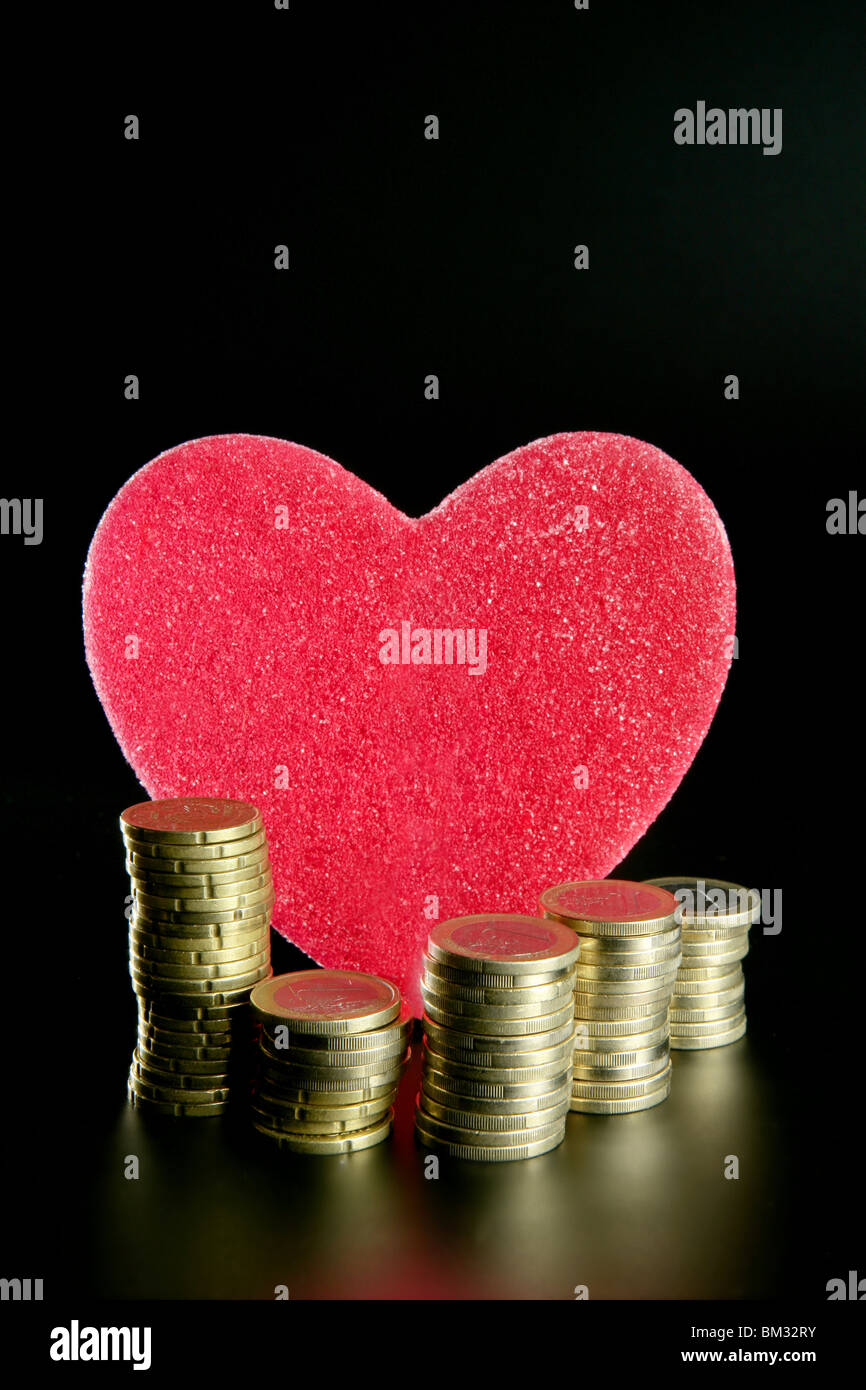 Love and money metaphor. Valentines candy heart and euro coins Stock ...