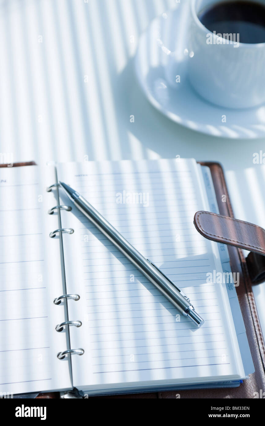 Diary, ballpoint pen and coffee Stock Photo - Alamy