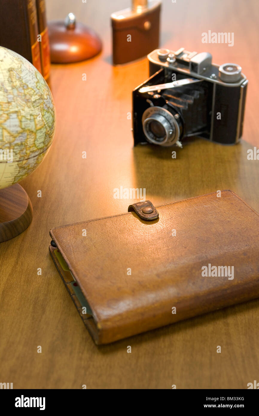 Diary, camera and globe on a desk Stock Photo - Alamy