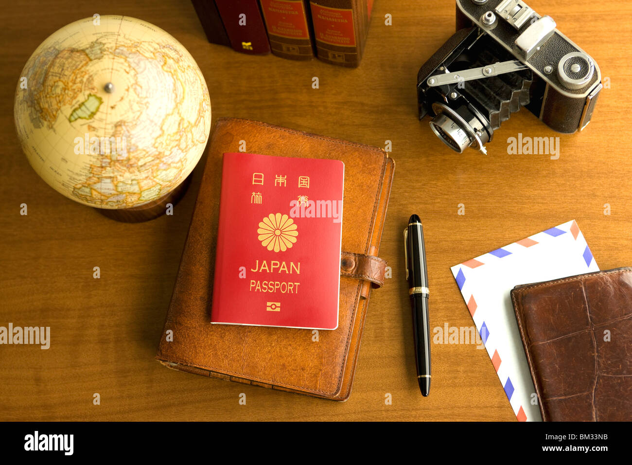 Diary, globe, camera and passport on a desk Stock Photo - Alamy