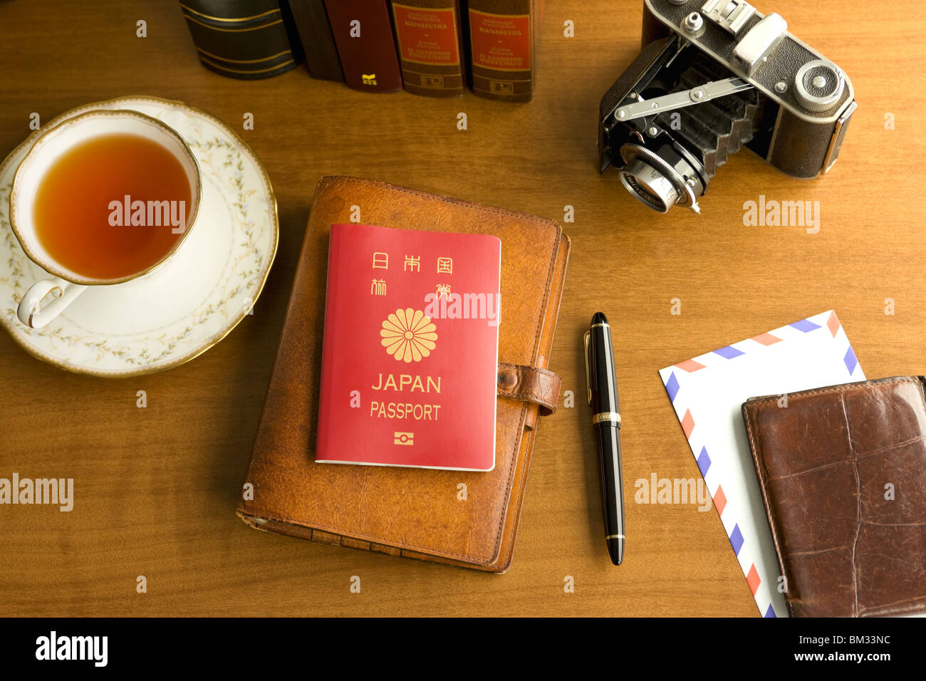 Diary, tea, camera and passport on a desk Stock Photo - Alamy