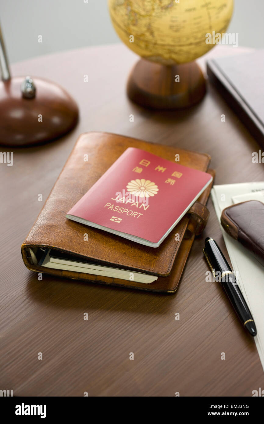 Diary, globe, camera and passport on a desk Stock Photo - Alamy