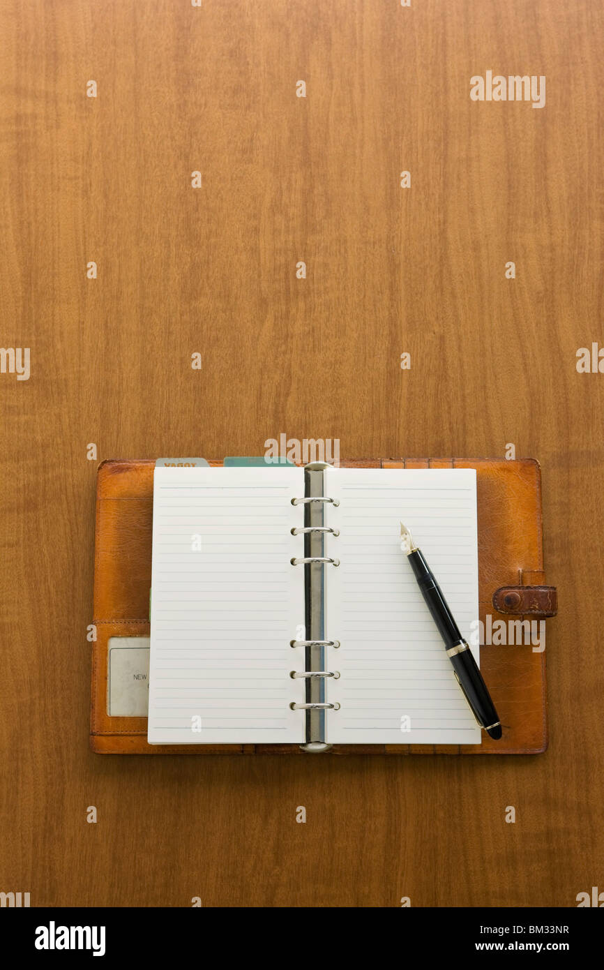 Open diary and ink pen on a desk Stock Photo - Alamy