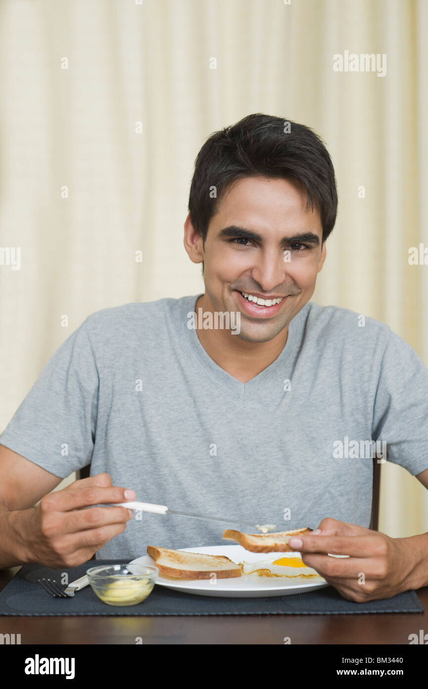 Portrait of a man having breakfast on a dining table Stock Photo - Alamy
