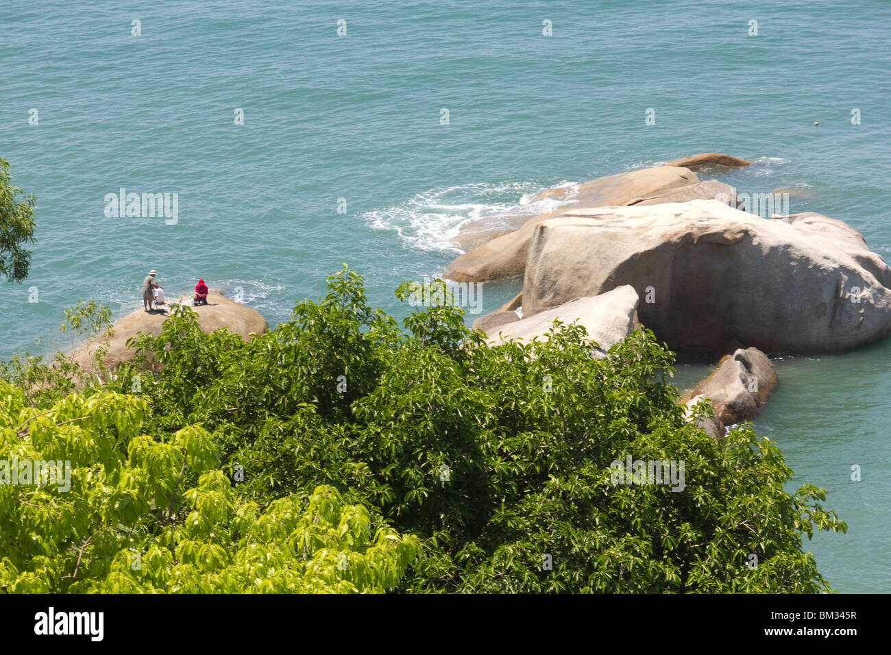 Men fishing off rocks at Tembeling Resort, Kuantan, Malaysia Stock ...