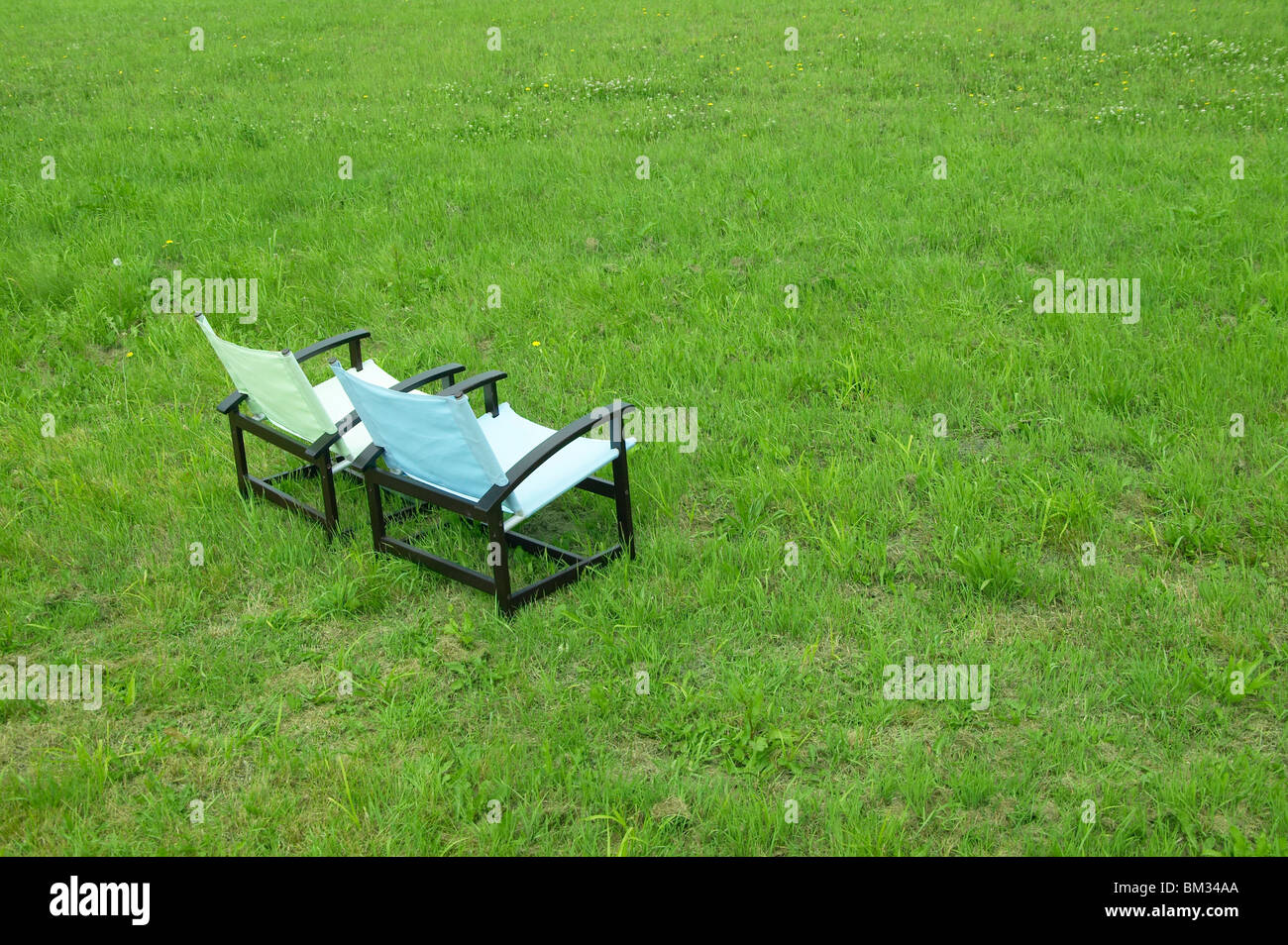 Two chairs in field Stock Photo - Alamy