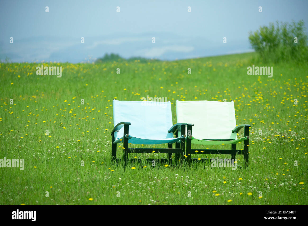 Two chairs in field Stock Photo - Alamy