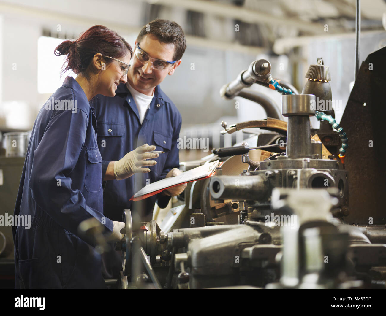 Engineer Teaching Female Apprentice Stock Photo - Alamy