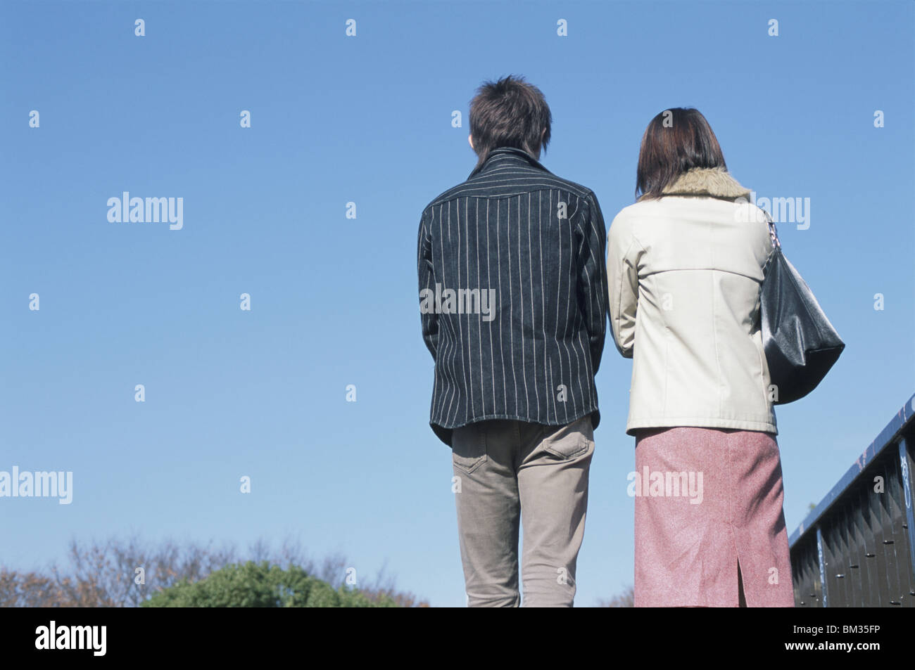 Rear view of couple standing Stock Photo - Alamy