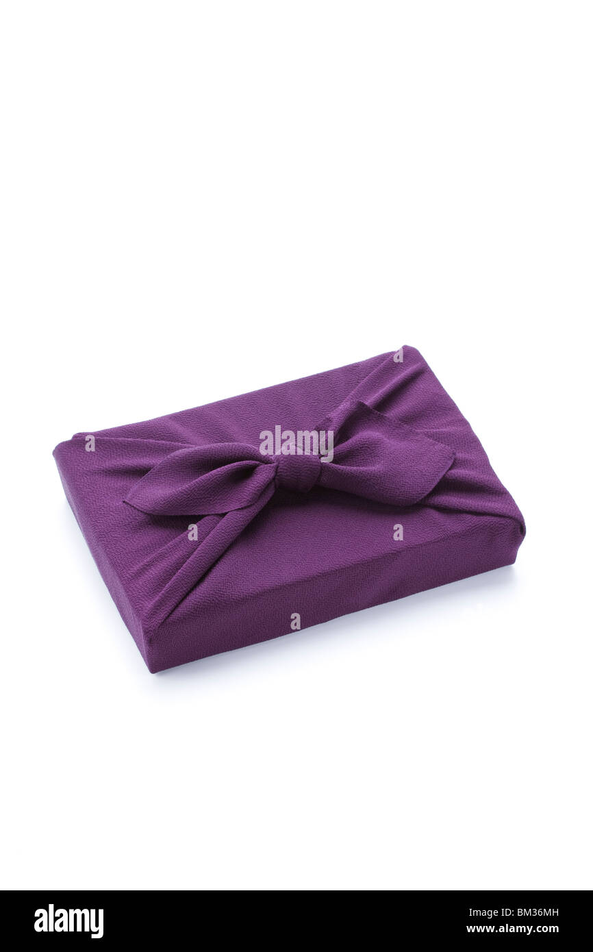 Box wrapped in purple cloth, white background Stock Photo - Alamy