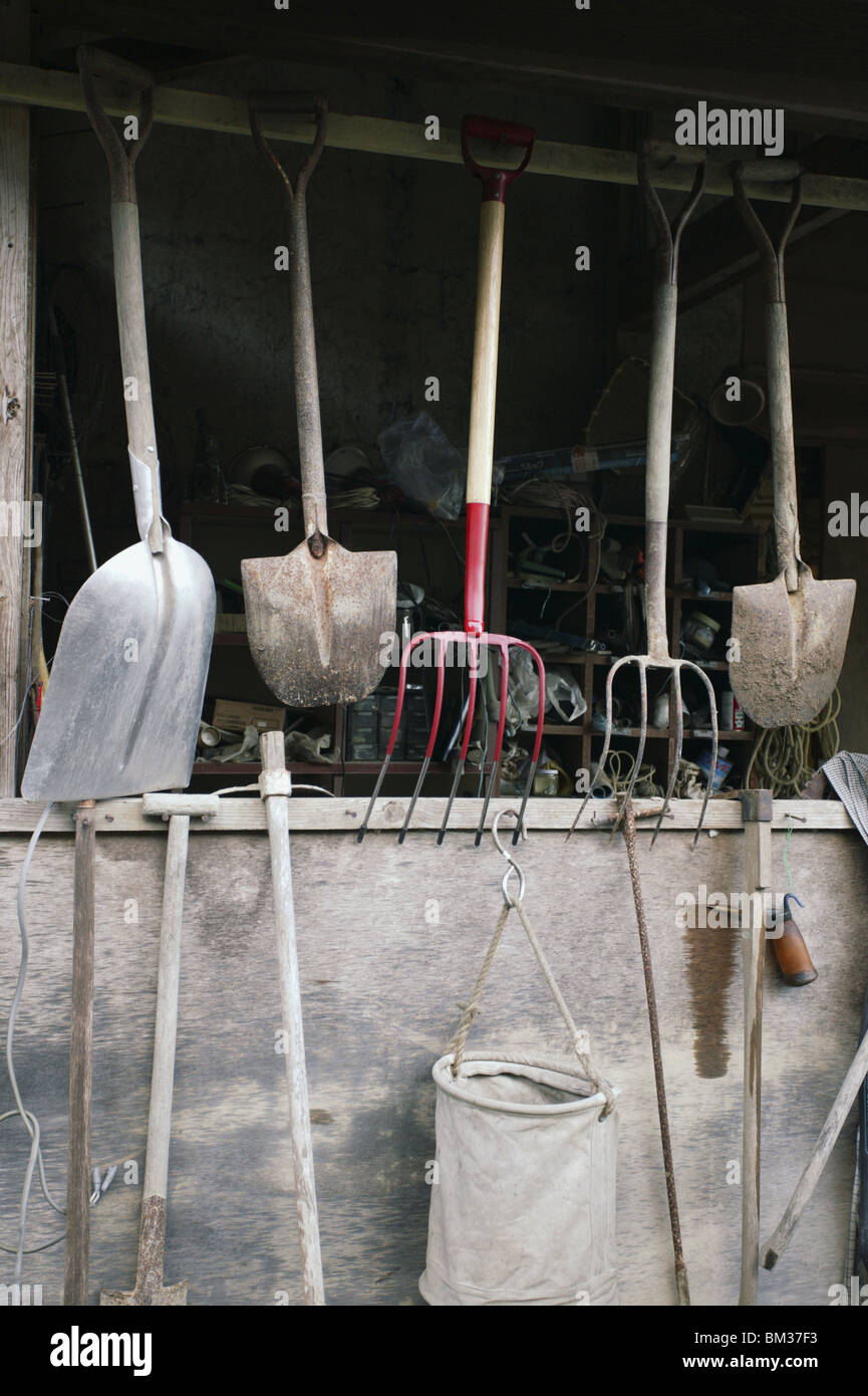 Farm tools in barn Stock Photo - Alamy