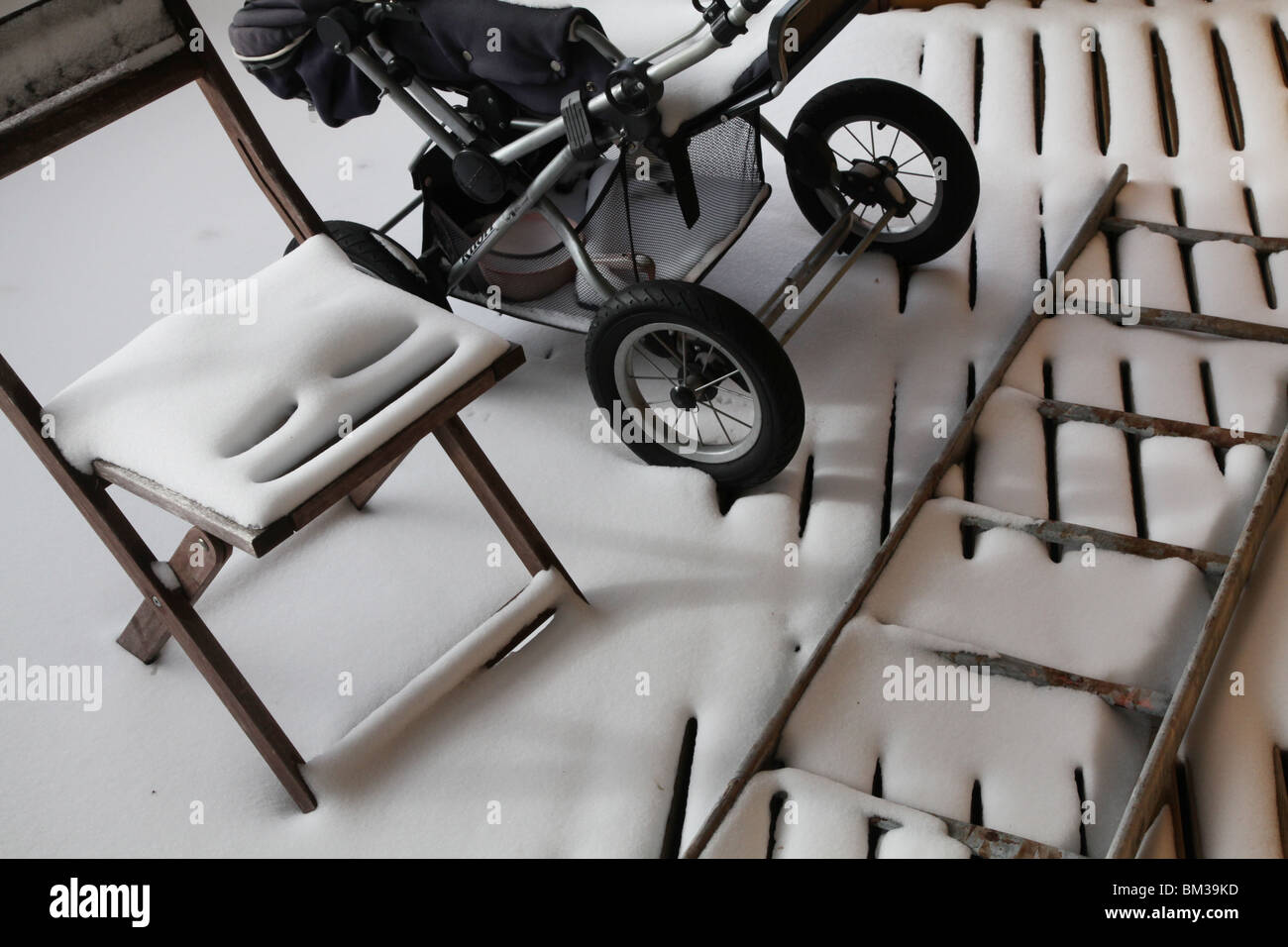 DRIFTING SNOW ON NORDIC VERANDA: Drifting snow covers a ladder pram ...