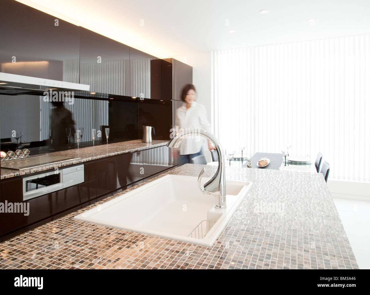 Woman in domestic kitchen Stock Photo - Alamy