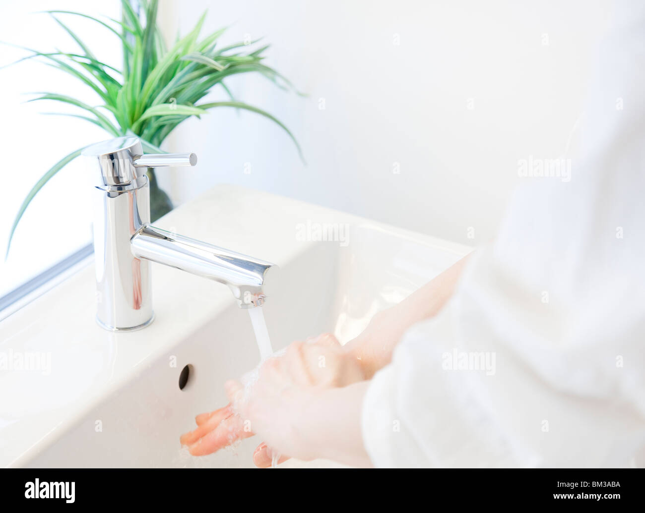 Woman washing hands Stock Photo - Alamy
