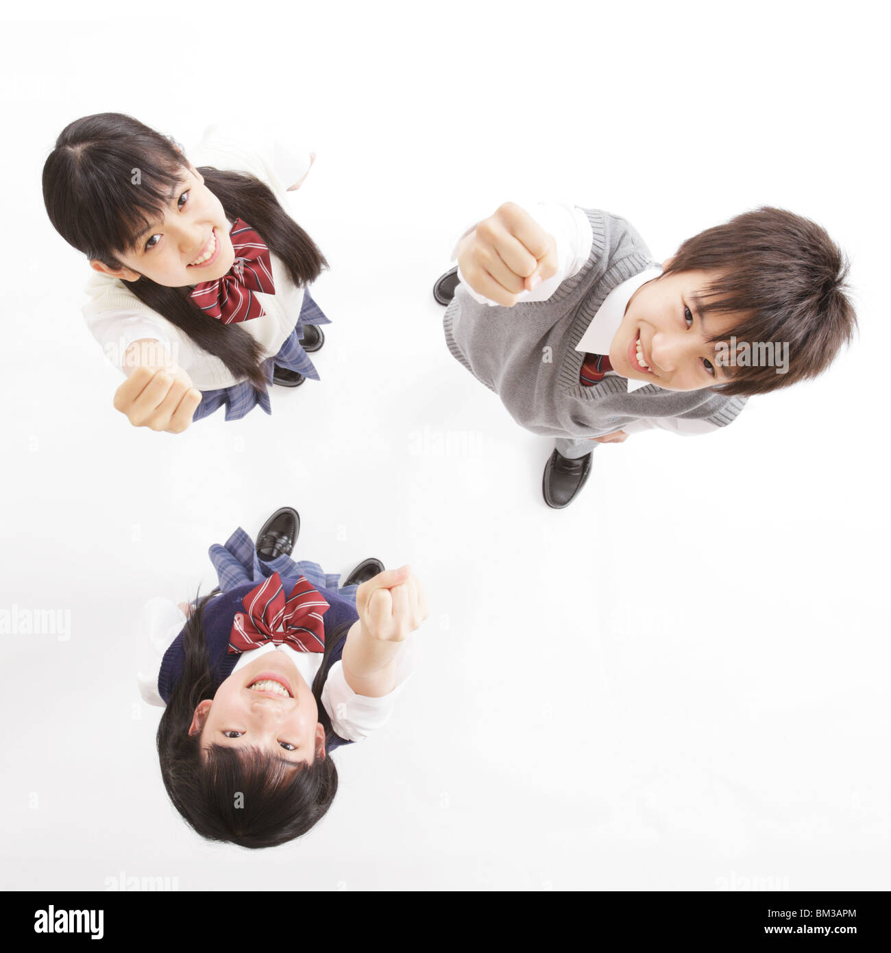 Portrait of school children looking up, smiling, white background Stock ...
