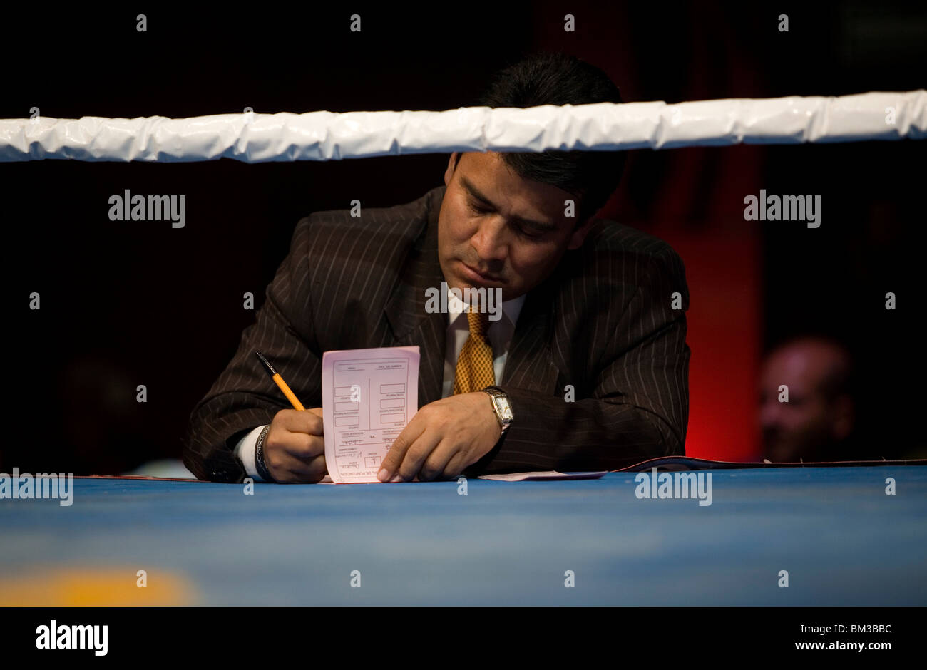 A boxing judge take notes during a bout in Mexico City, December 9 ...