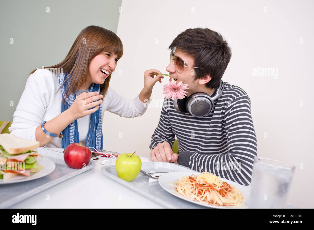 Student cafeteria - teenage couple having fun during lunch break Stock ...
