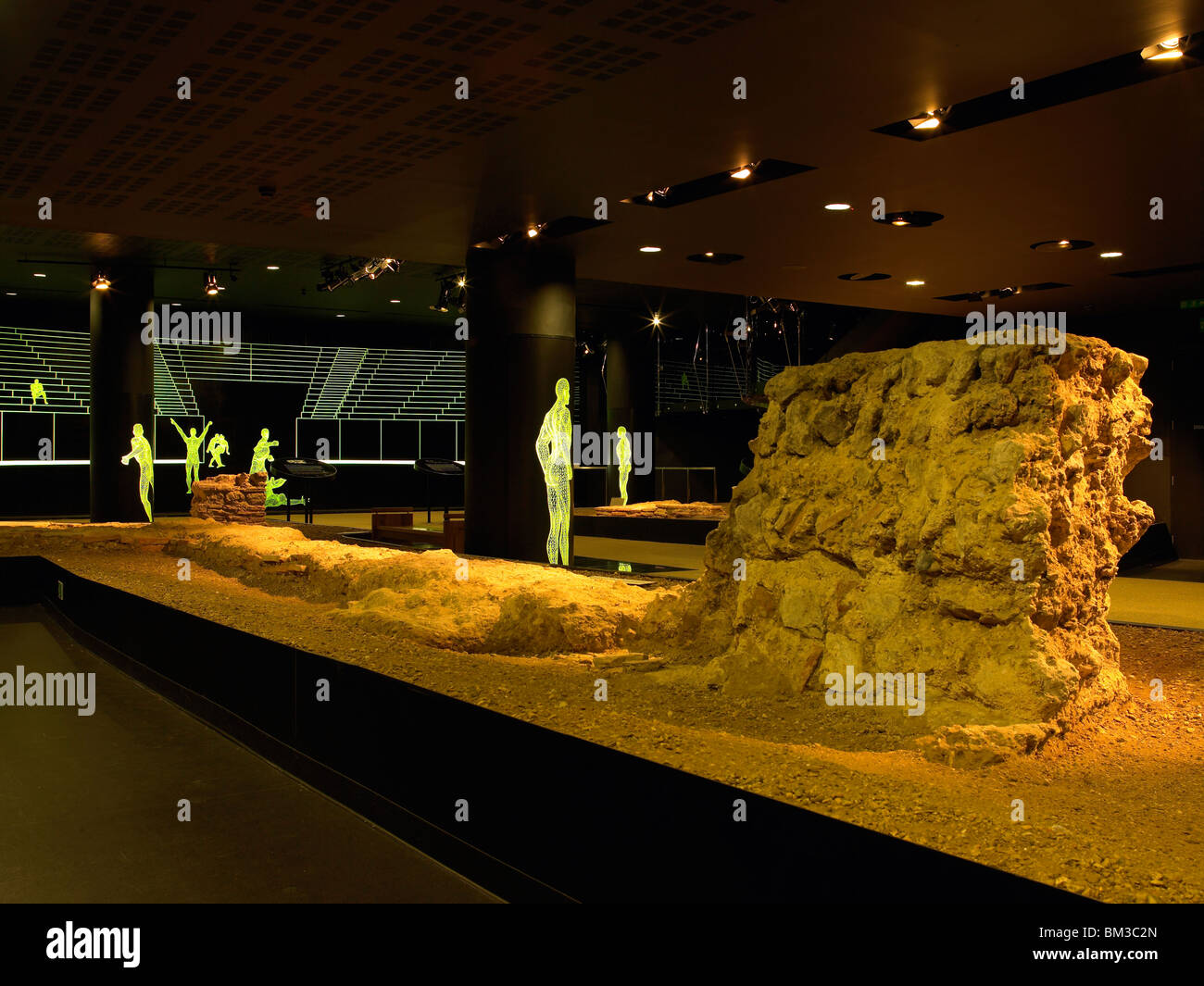 neon figures in a roman underground display featuring remains of ...