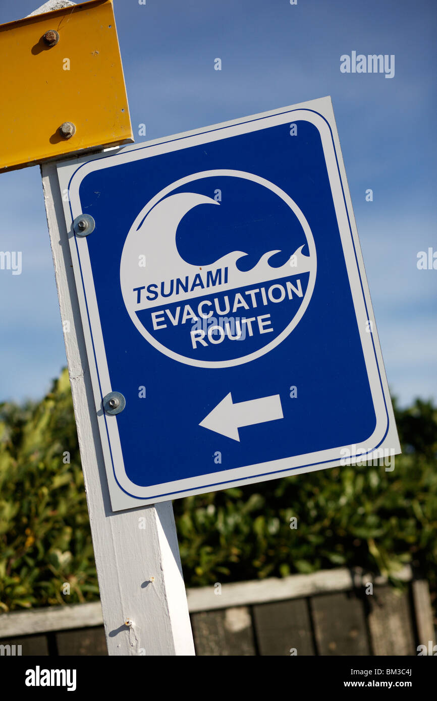 A road sign pointing towards a tsunami escape route in New Zealand ...